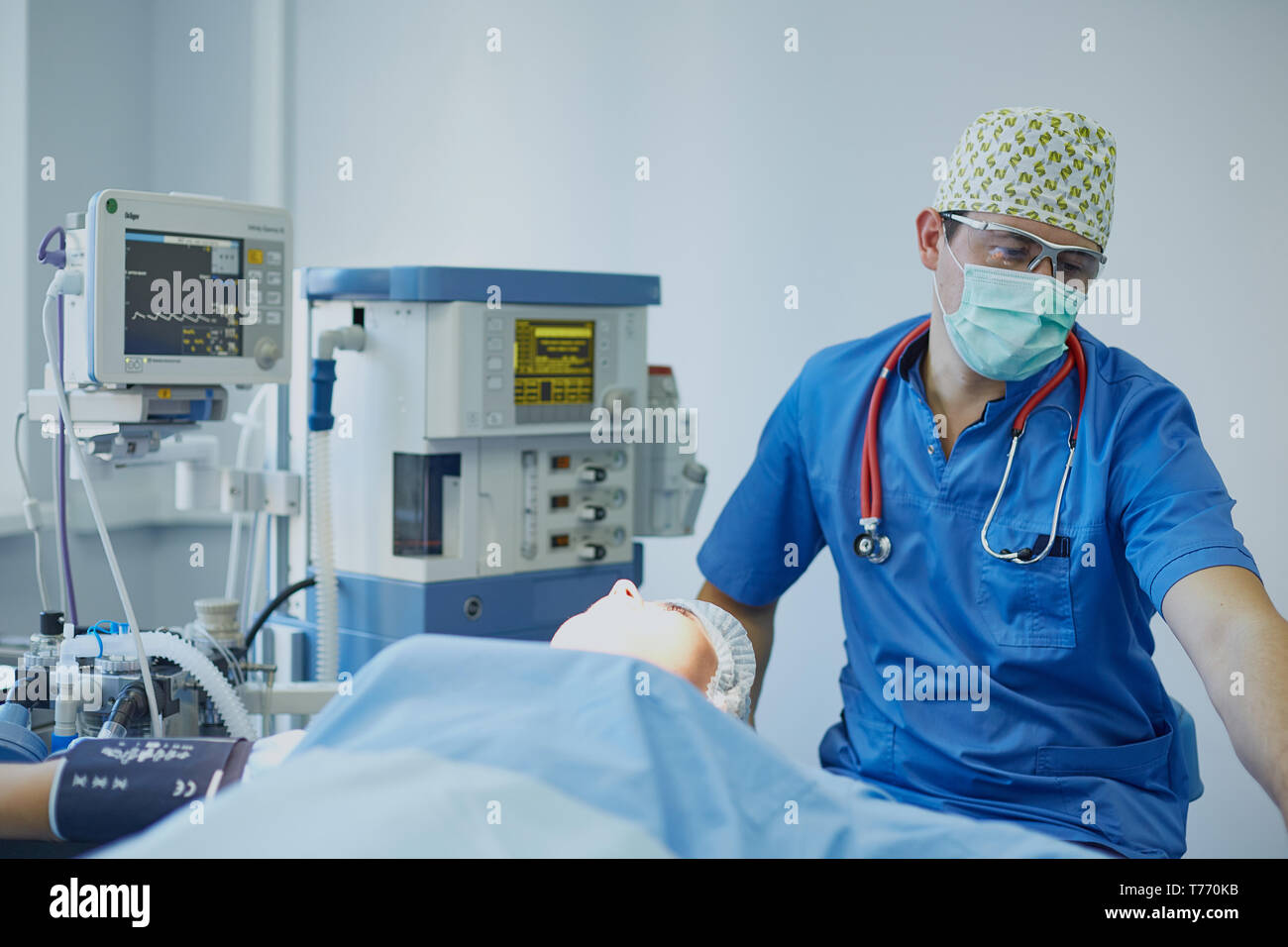 Several doctors surrounding patient on operation table during their ...