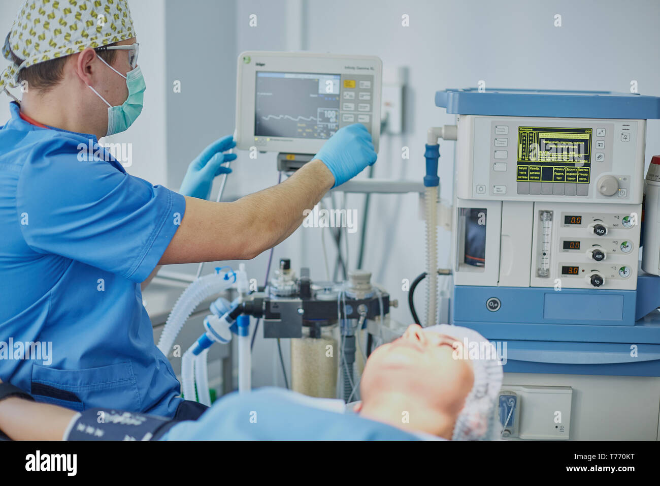 Several doctors surrounding patient on operation table during their ...