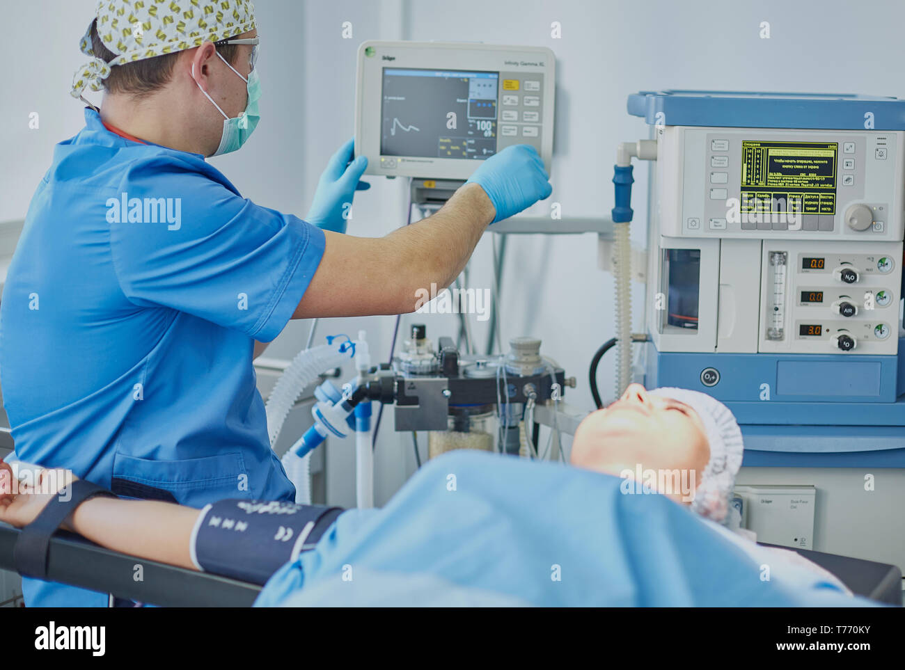 Several doctors surrounding patient on operation table during their ...