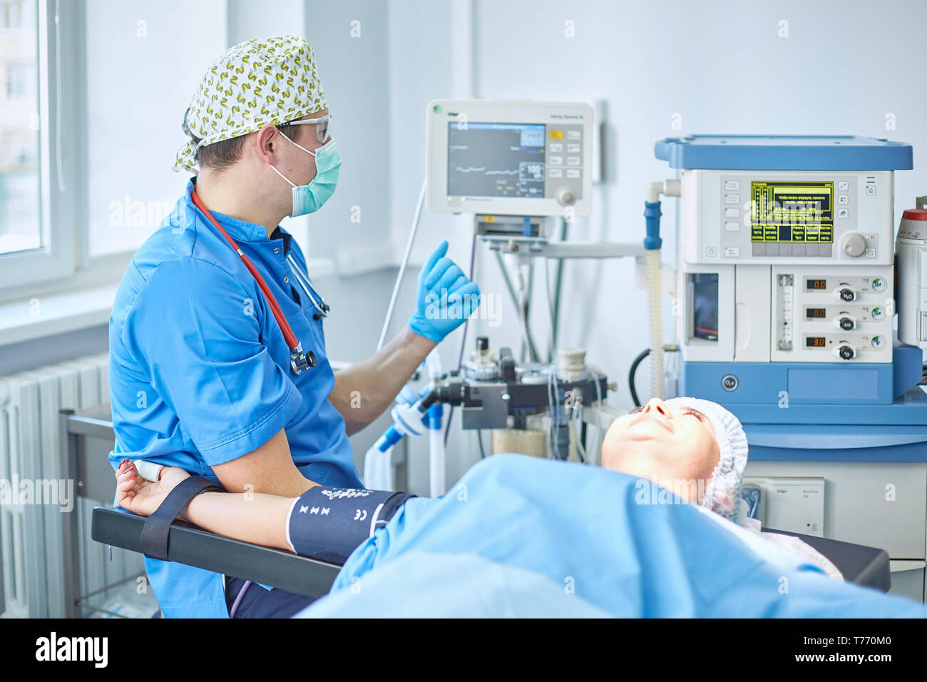 Several doctors surrounding patient on operation table during their ...