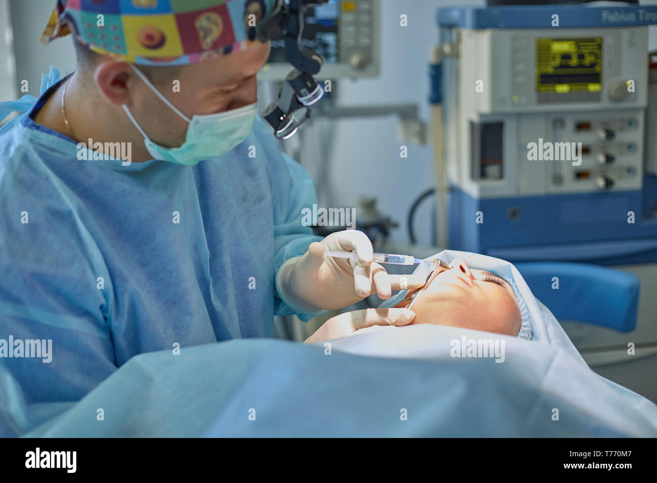 Several doctors surrounding patient on operation table during their ...