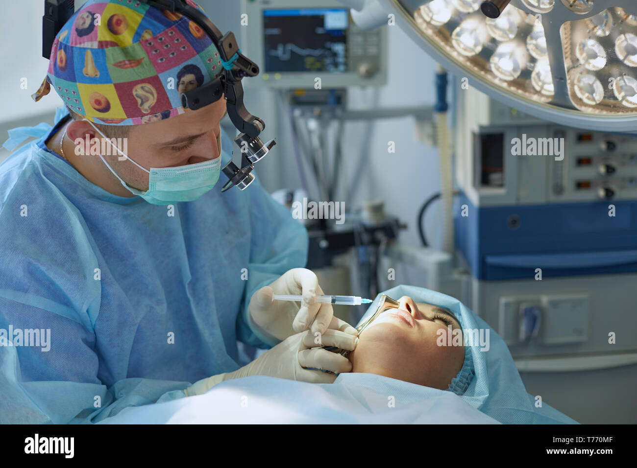 Several doctors surrounding patient on operation table during their ...