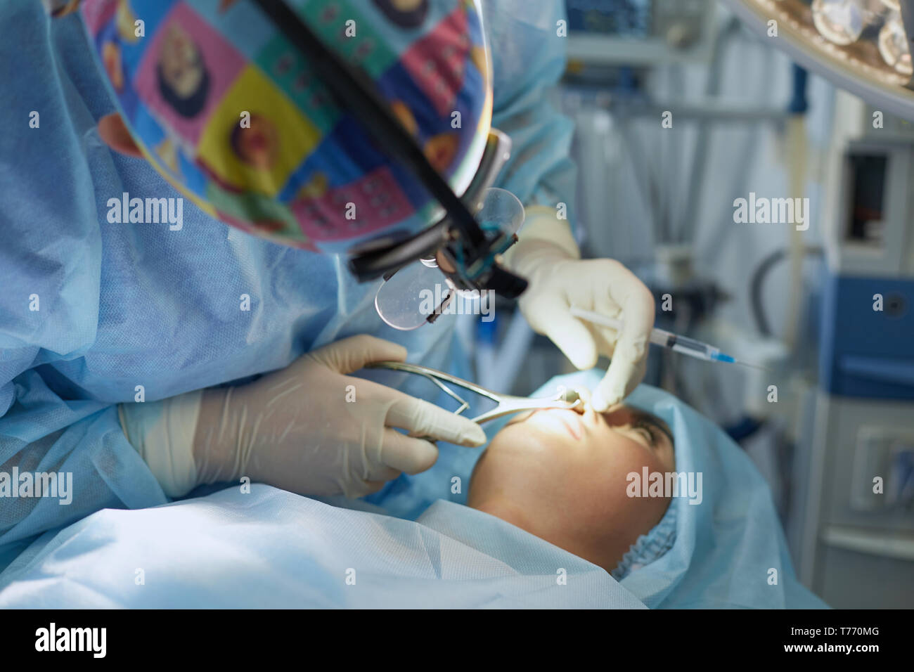 Several doctors surrounding patient on operation table during their ...