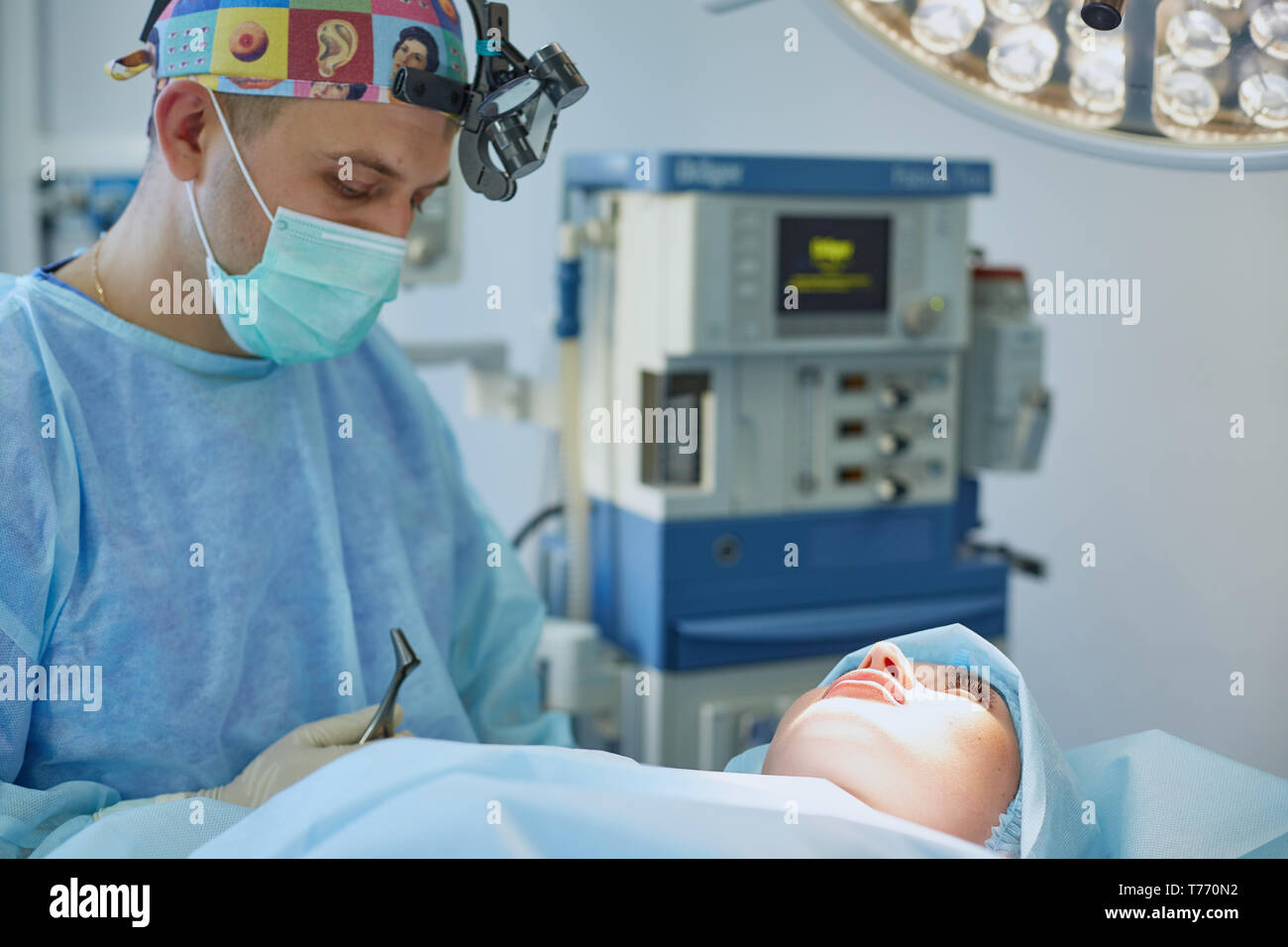 Several doctors surrounding patient on operation table during their ...