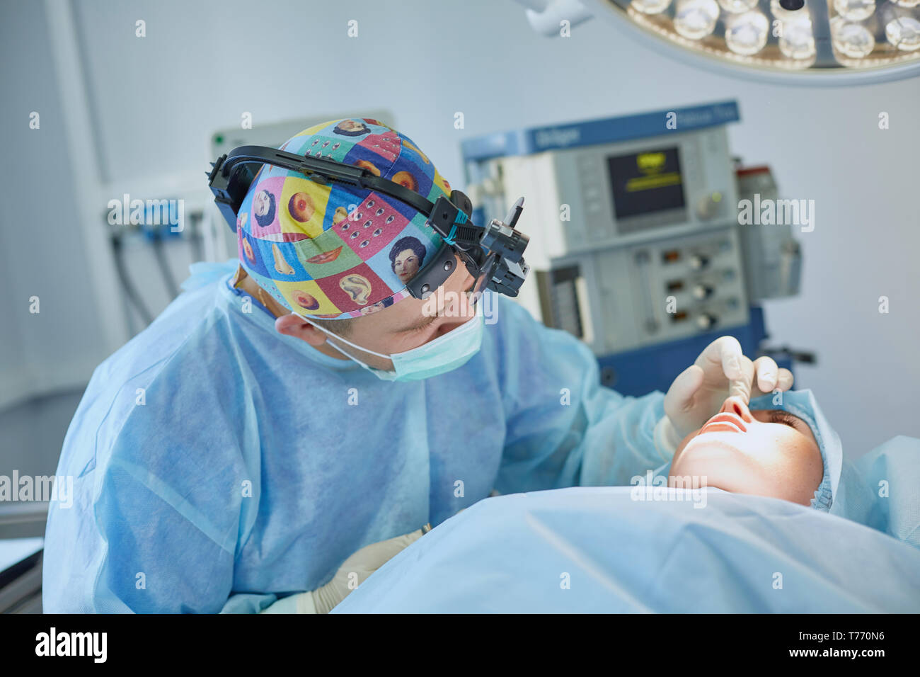 Several doctors surrounding patient on operation table during their ...