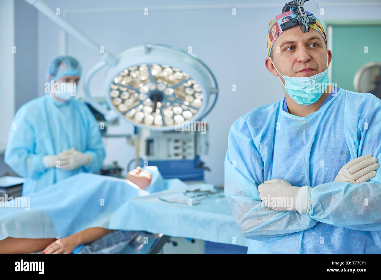 Several doctors surrounding patient on operation table during their ...