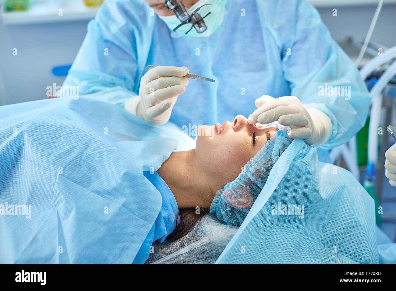 Several doctors surrounding patient on operation table during their ...