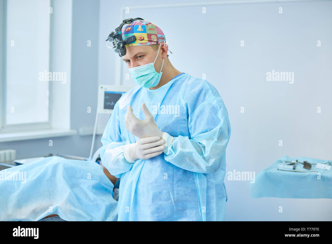 Several doctors surrounding patient on operation table during their ...