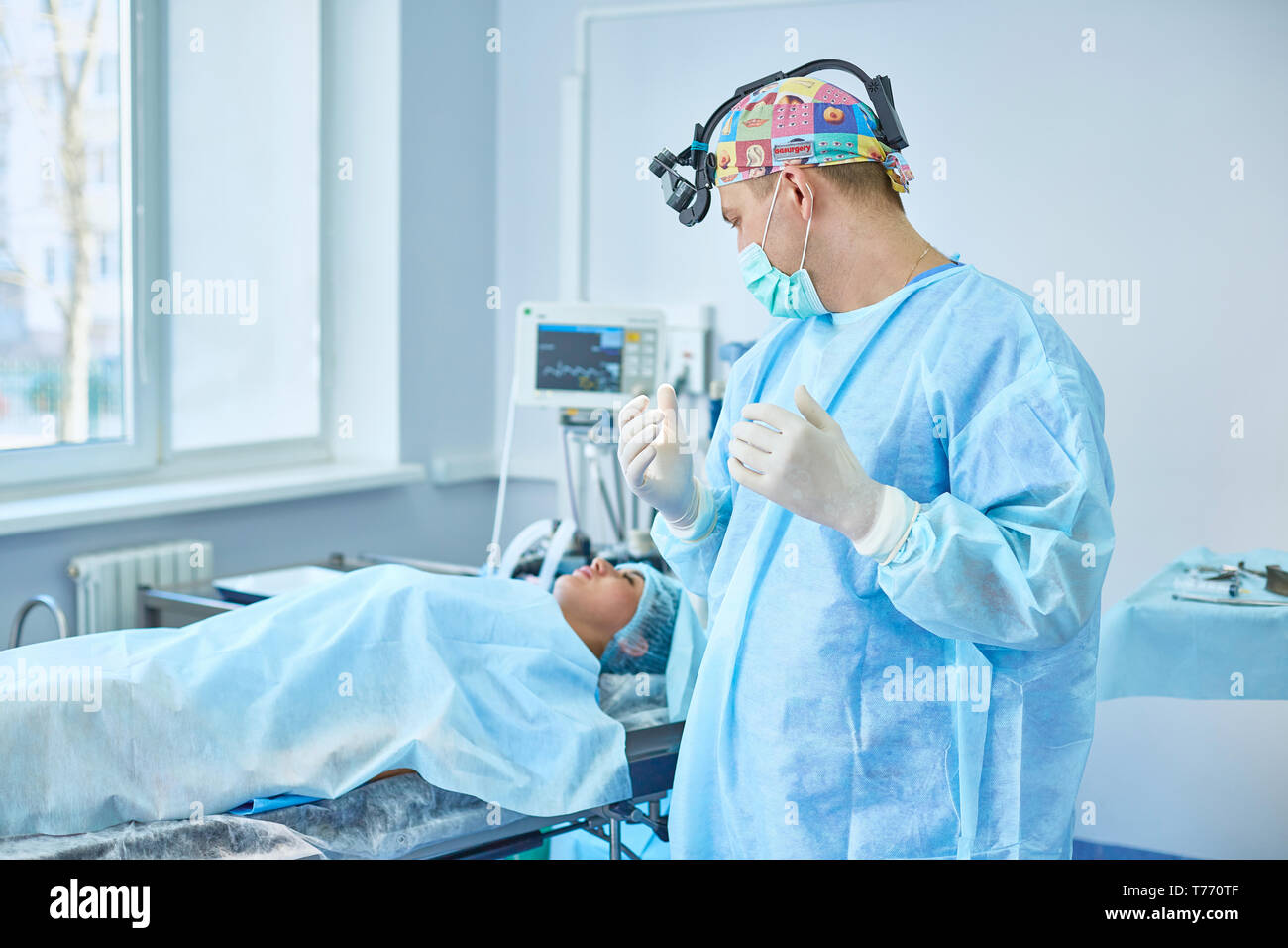 Several doctors surrounding patient on operation table during their ...