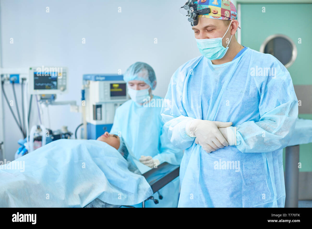 Several doctors surrounding patient on operation table during their ...