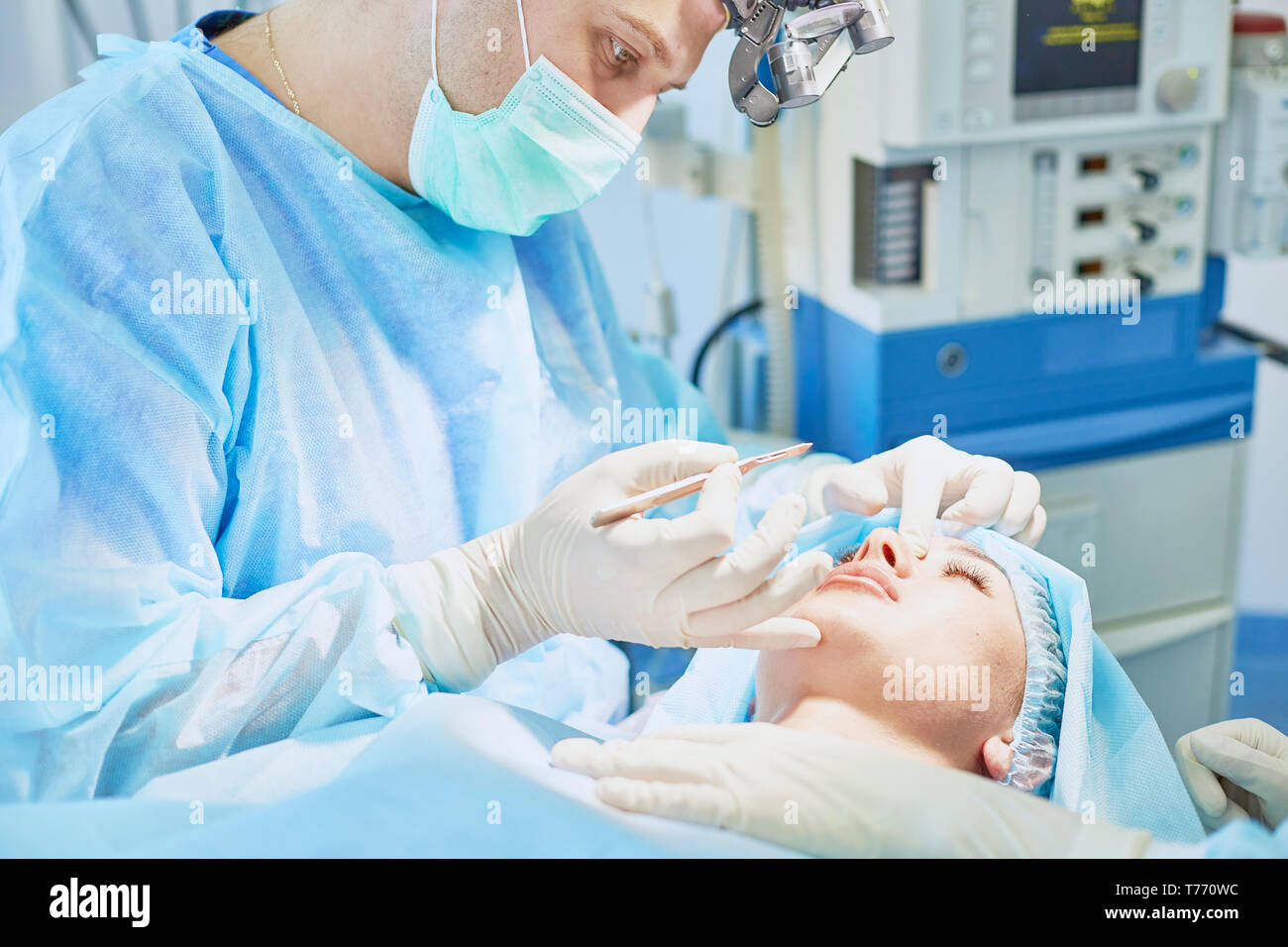 Several doctors surrounding patient on operation table during their ...