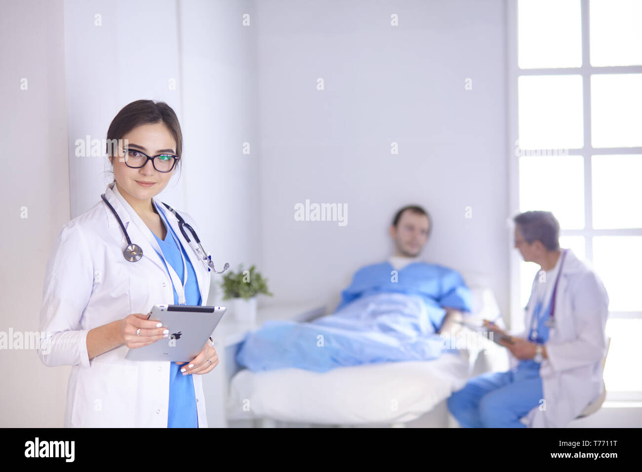 Doctor checking heart beat of patient in bed with stethoscope Stock ...