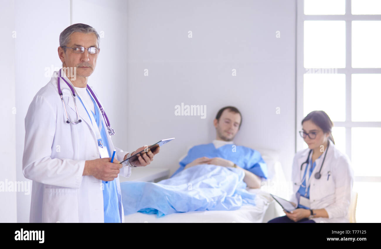 Doctor checking heart beat of patient in bed with stethoscope Stock ...
