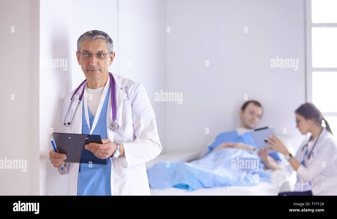 Doctor checking heart beat of patient in bed with stethoscope Stock ...