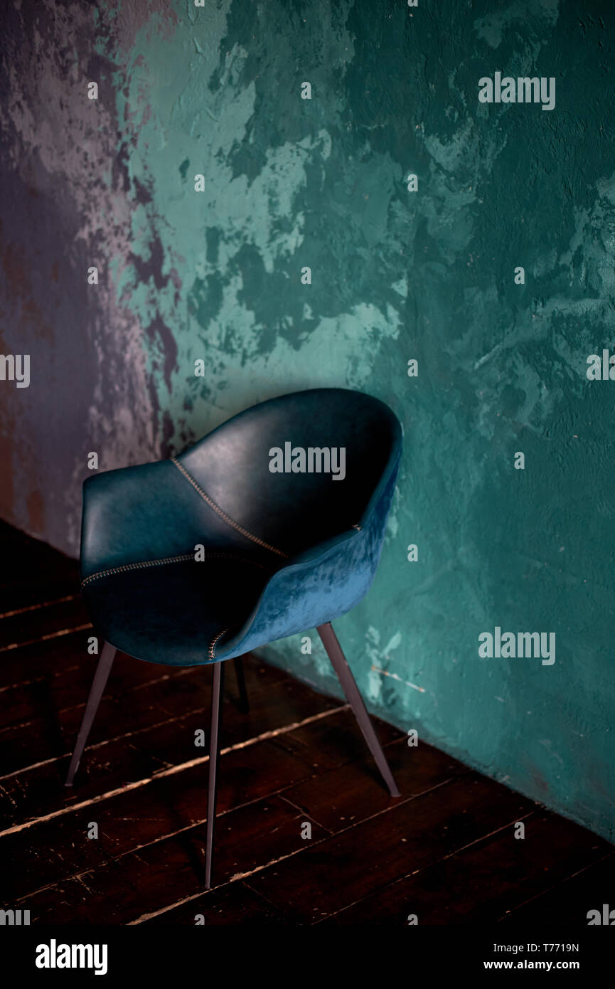 The chair on the textured background of the wall of turquoise and lilac ...