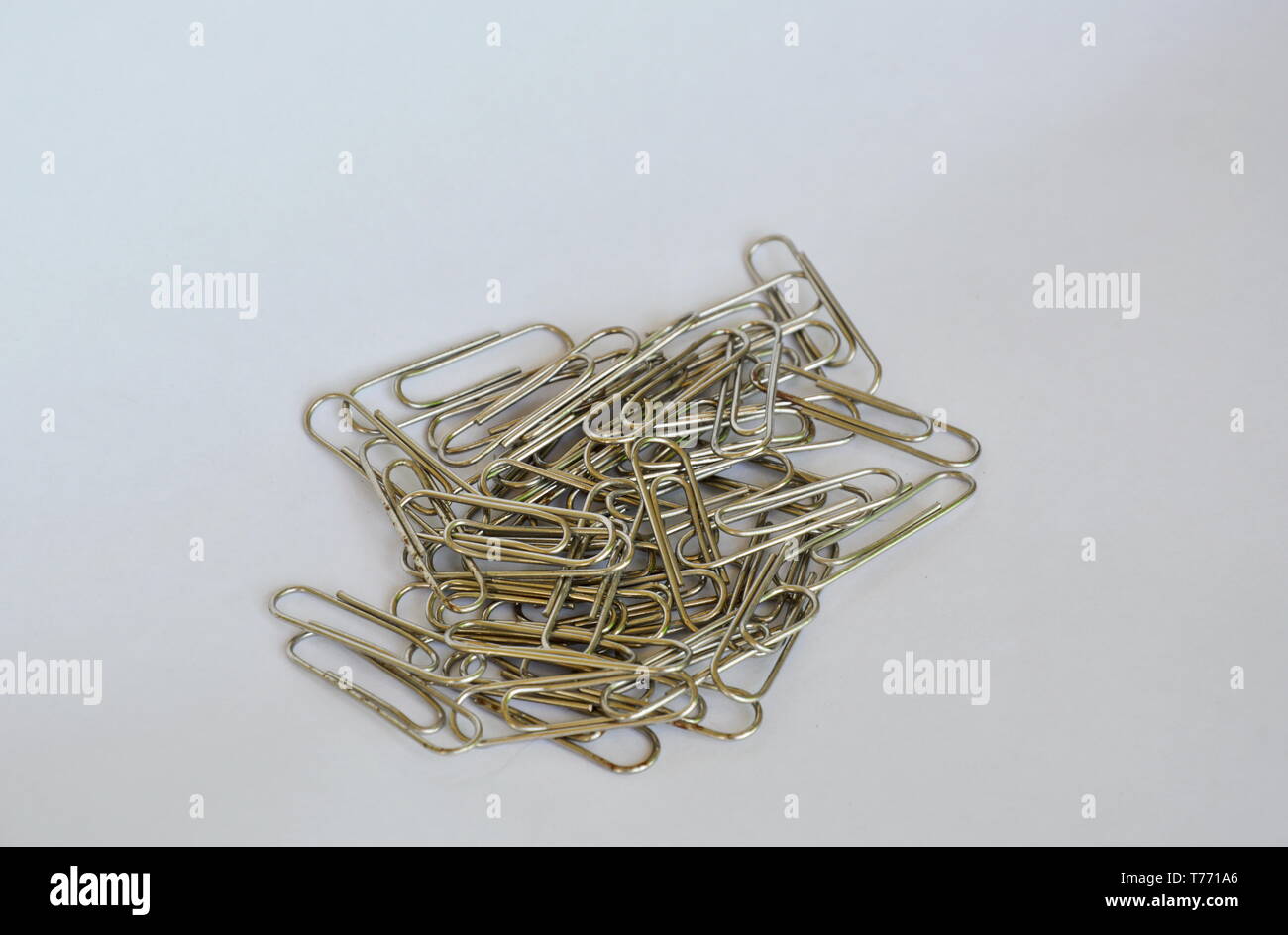 white and silver paperclip on white background Stock Photo - Alamy