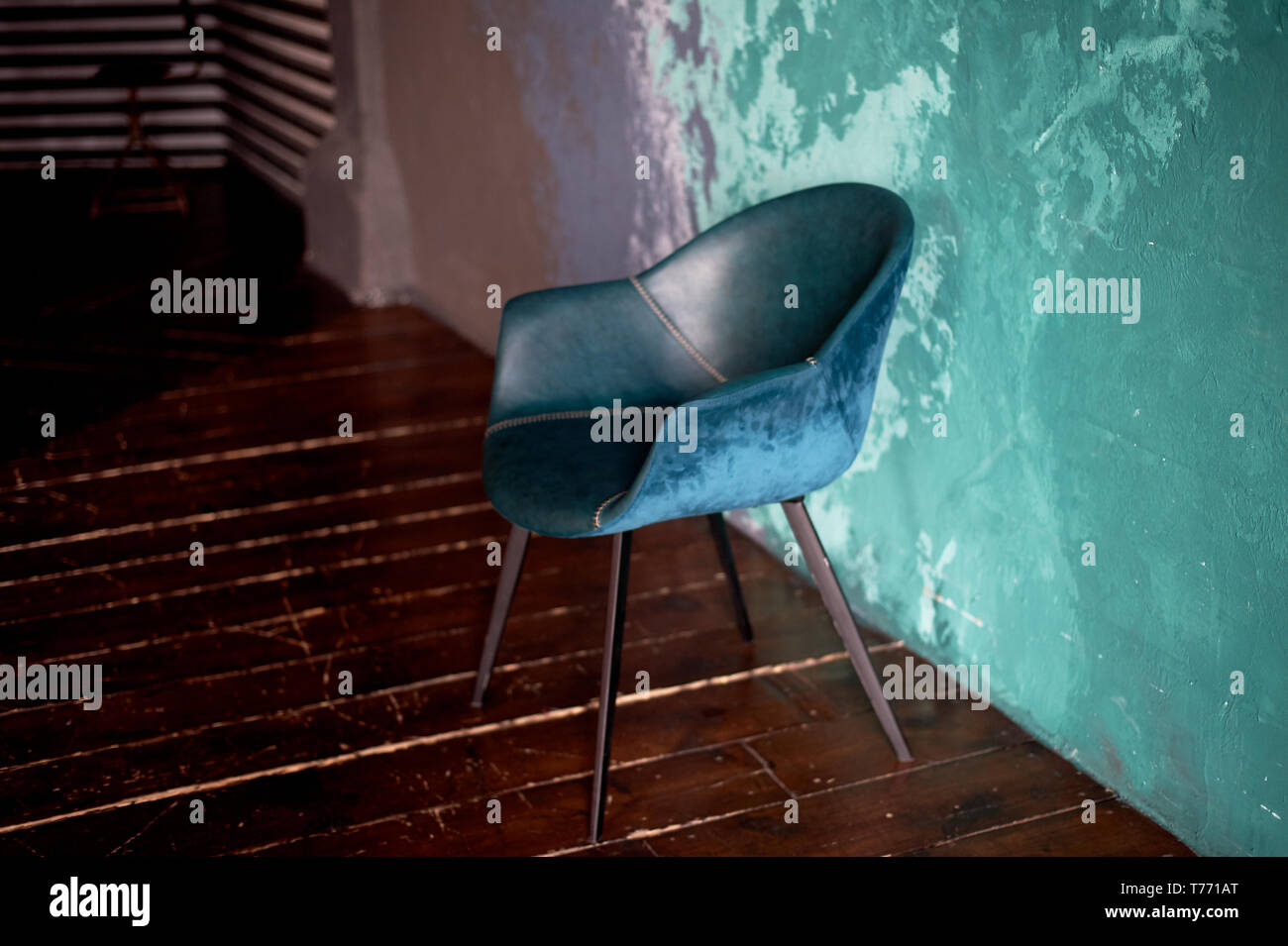The chair on the textured background of the wall of turquoise and lilac ...