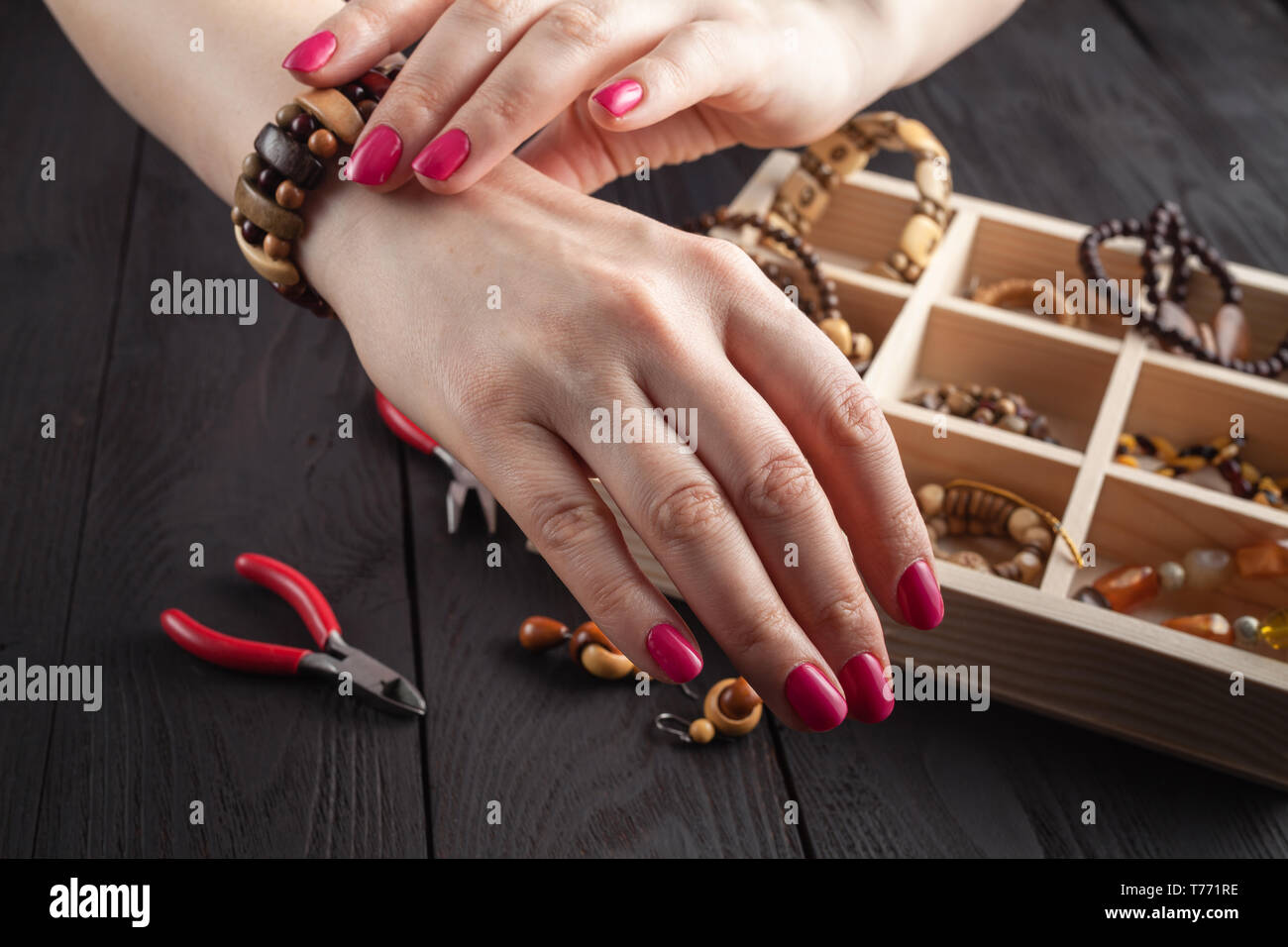 Making of handmade jewellery. Woman trying a homemade bracelet Stock ...