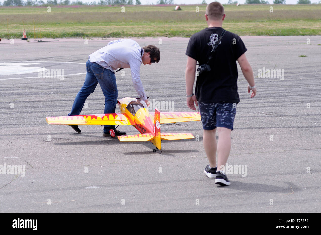 Man operator preparing a radio controlled airplane for flight, the ...