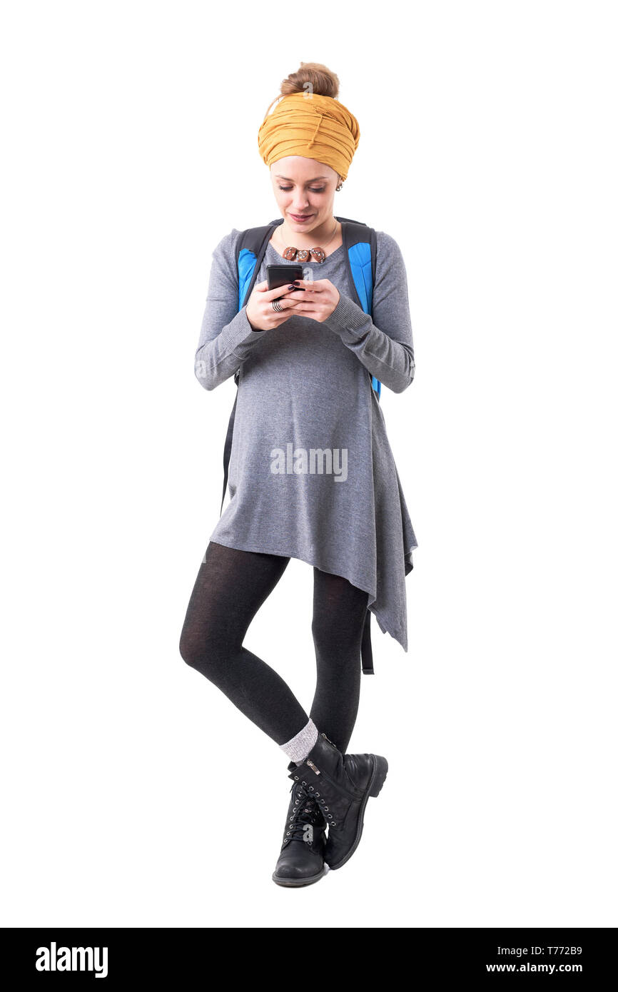 Relaxed hipster millennial girl carrying backpack using mobile phone ...