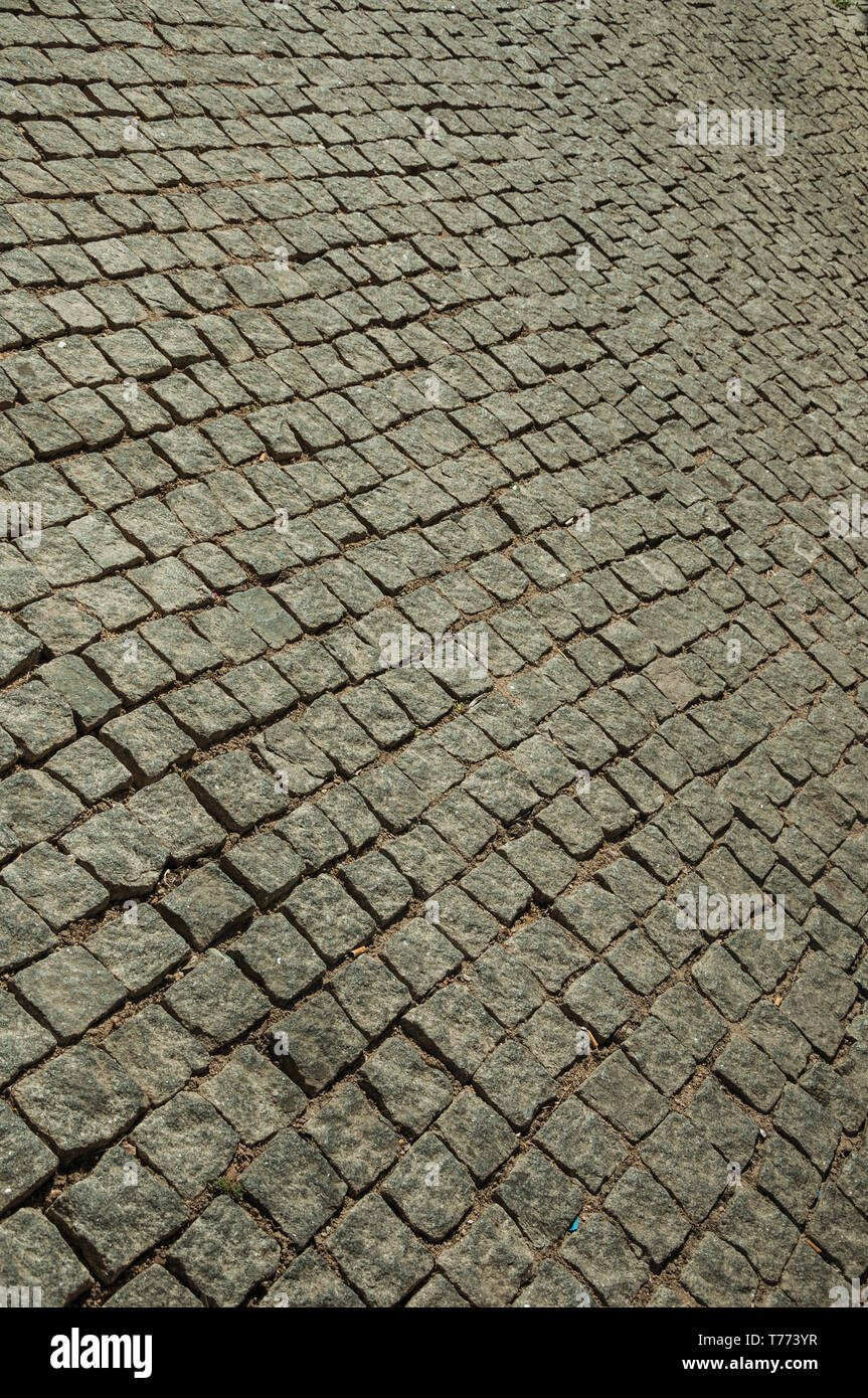 Pavement made of granite setts on alley, forming a singular background ...