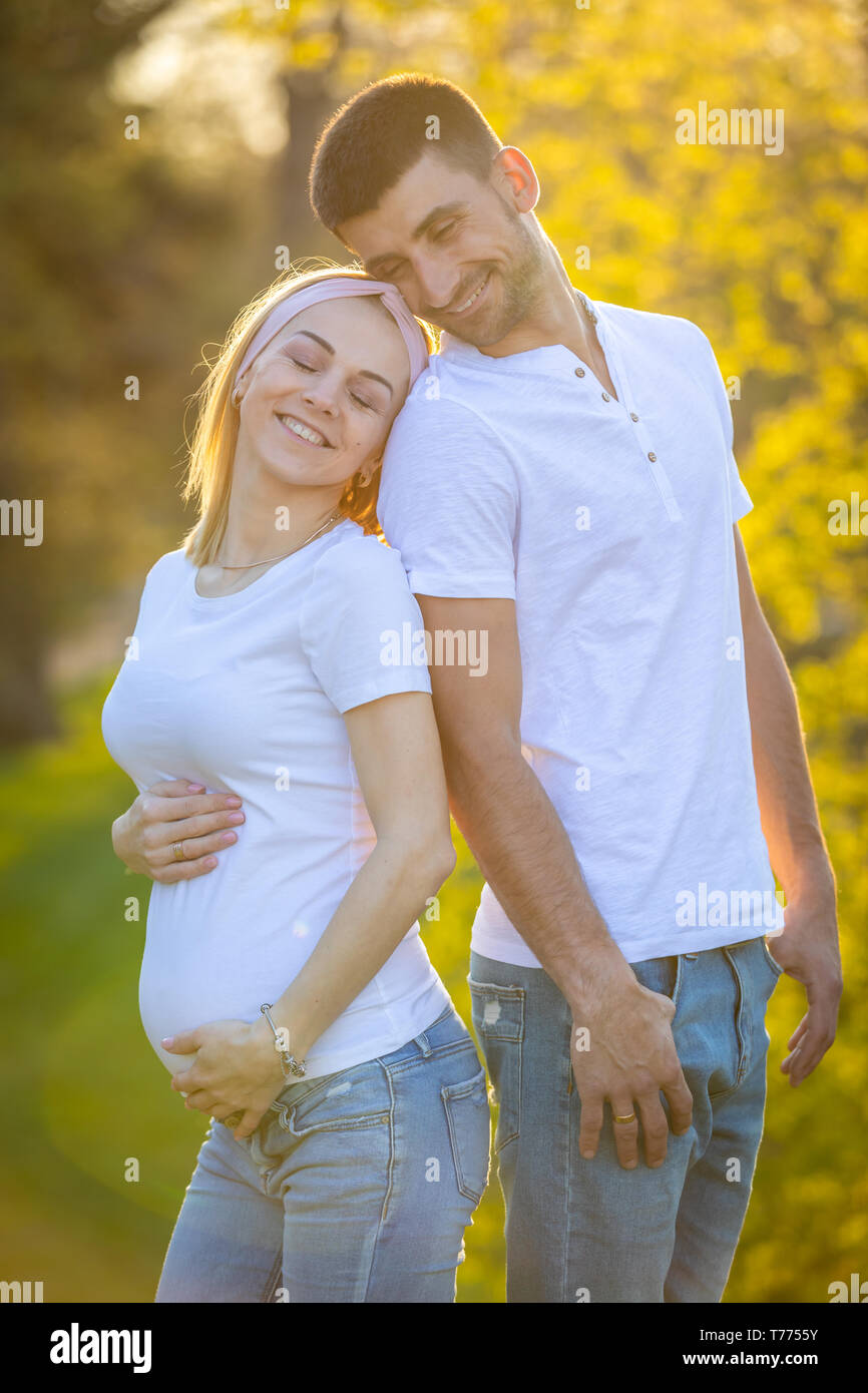 Happy couple expecting baby, pregnant woman with husband, young family ...