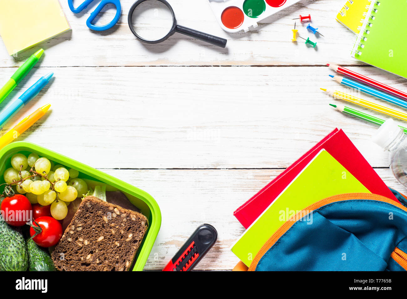 Back to school concept. Lunch box with stationery and backpack Stock ...