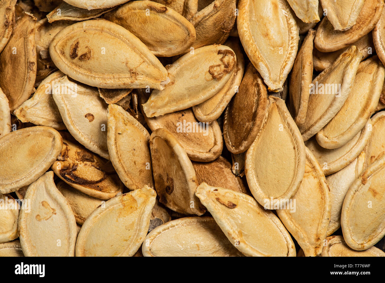 Roasted pumpkin seeds, fried in oven, macro look, top view Stock Photo ...