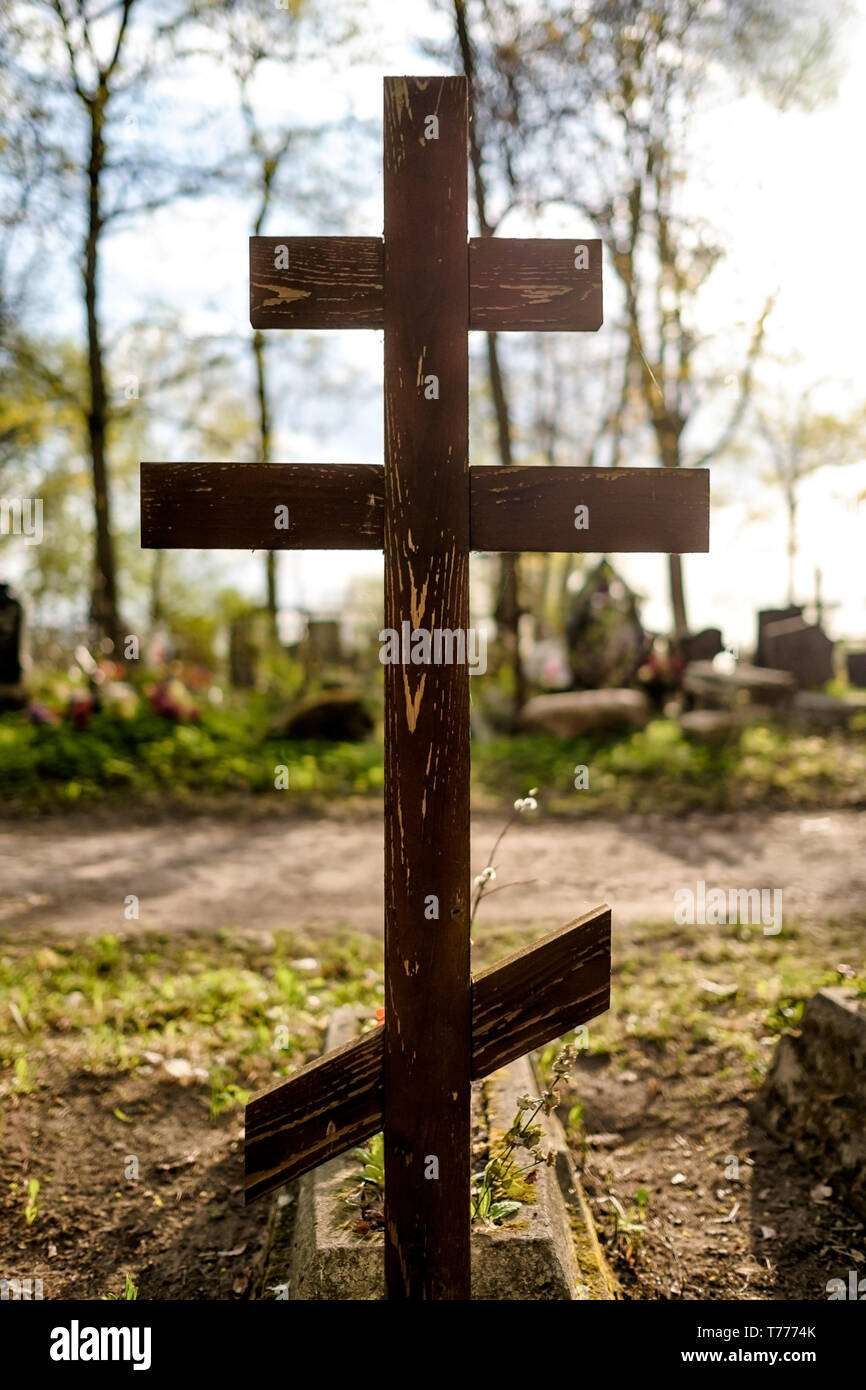 Grave cross on the Orthodox Christian cemetery at sunny day in Russia ...