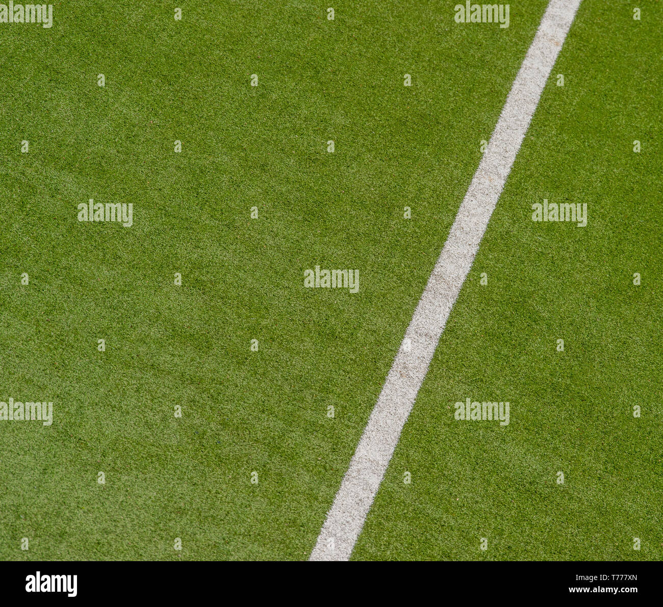 Artificial green turf texture background with white line marks Stock ...