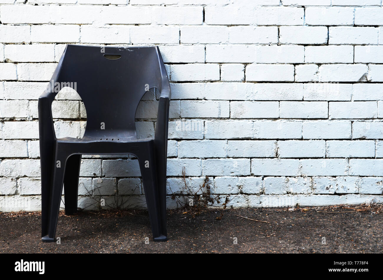 Self-Isolation chair against brick wall Stock Photo - Alamy