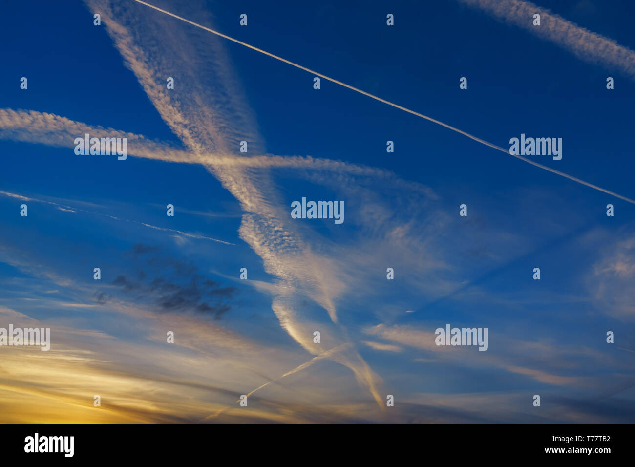 Blue sky and contrails Stock Photo - Alamy