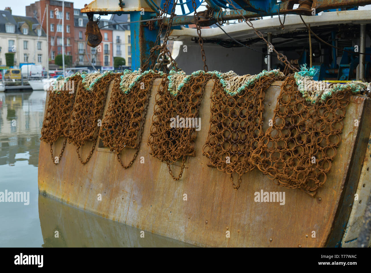 Rusty nets for catching scallops hang on a boat Stock Photo - Alamy
