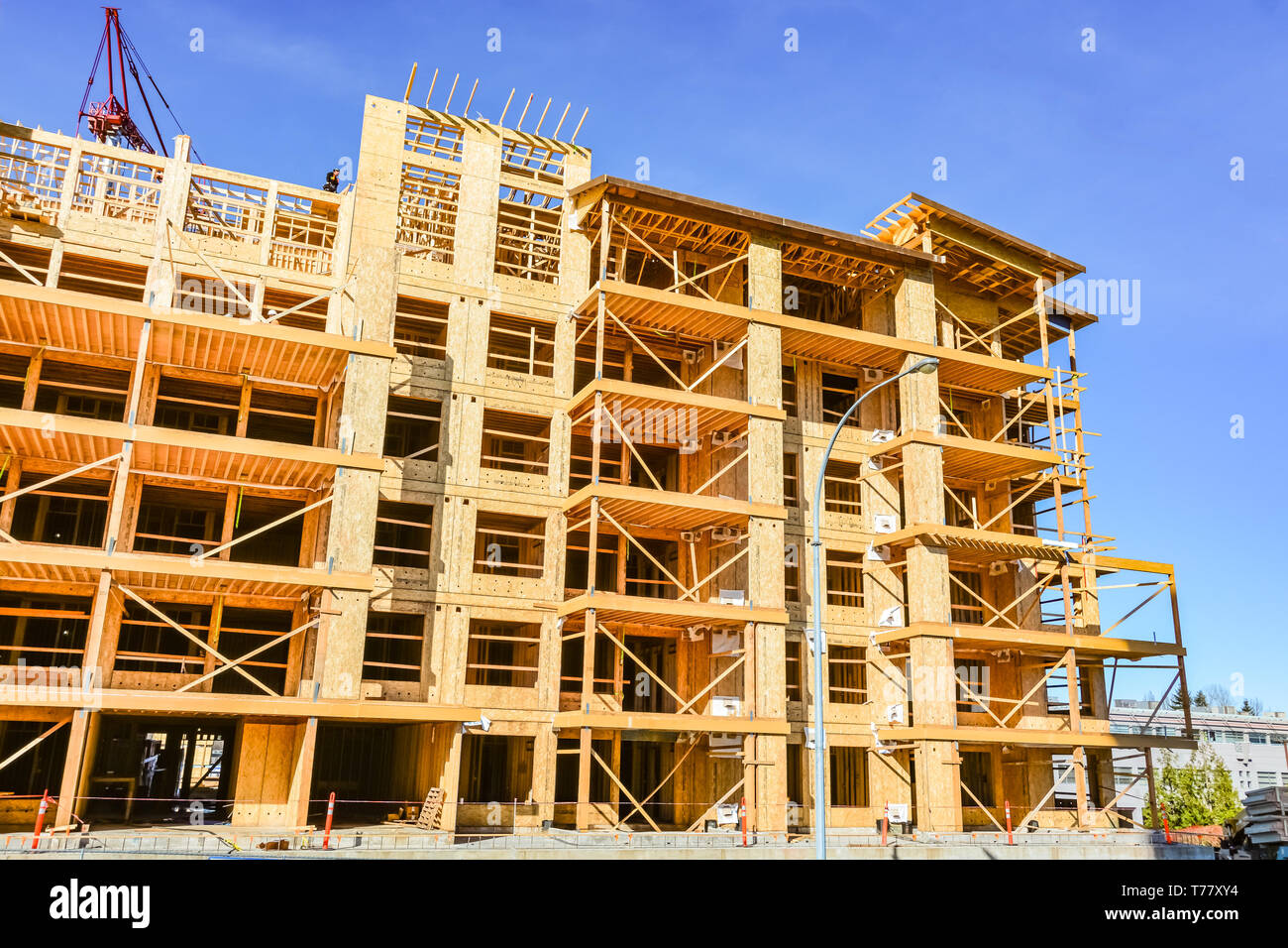 Six storey frame building under construction on concrete foundation bed ...