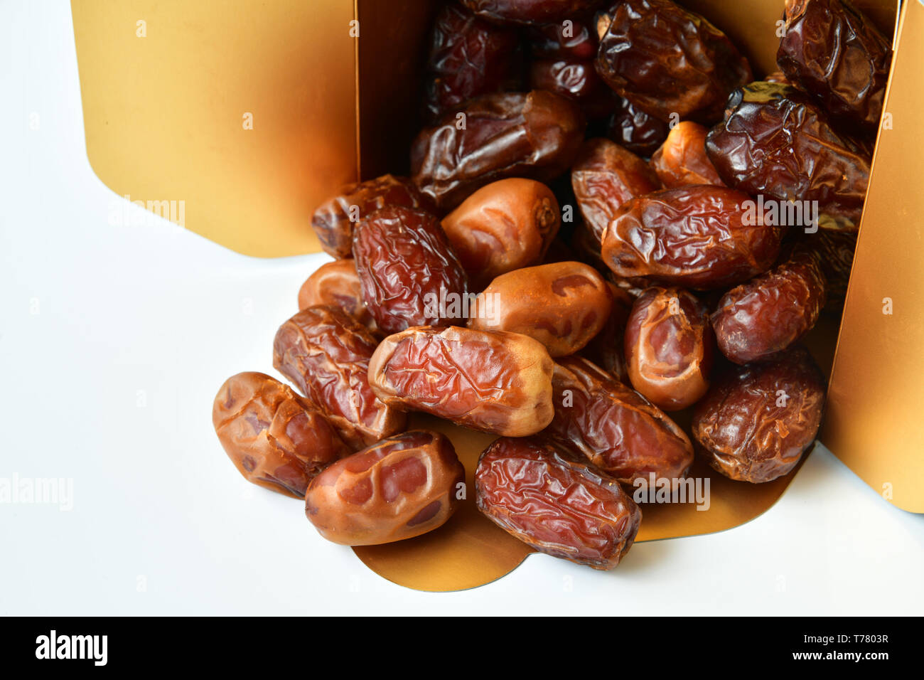 Dried dates in a box on white background Stock Photo - Alamy