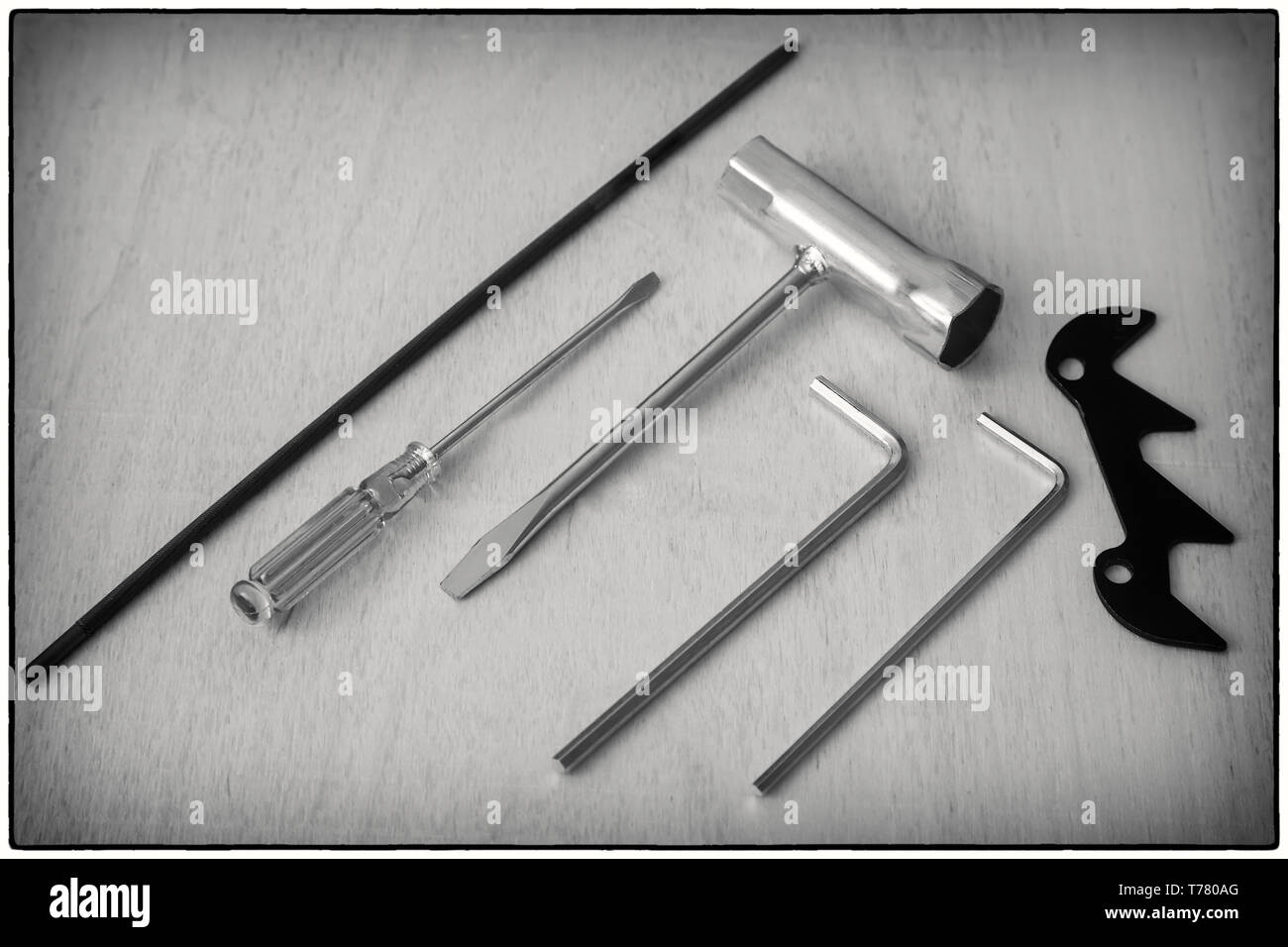 On the wooden table are locksmith tools for work. Black and white image ...