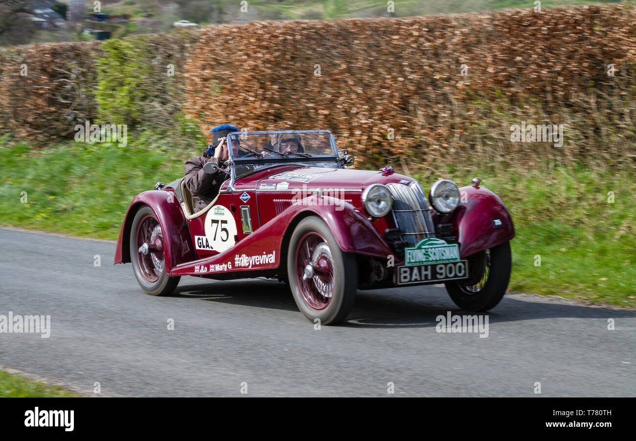 A 1936 Riley TT Sprite climbs Southwaite Hill in Cumbria, England. The ...