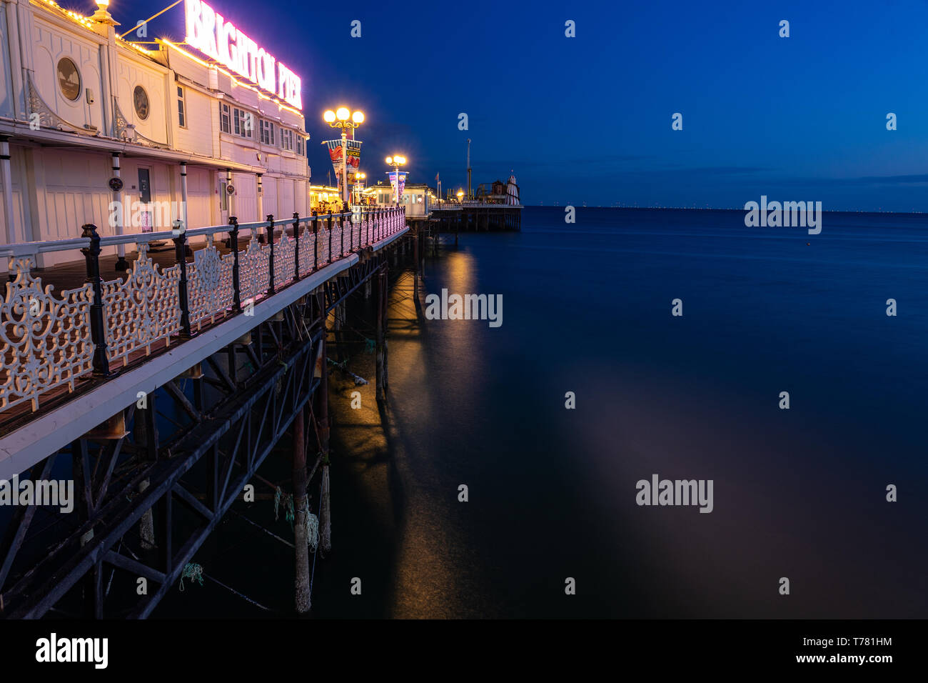 Pier lights reflected in the sea Stock Photo - Alamy