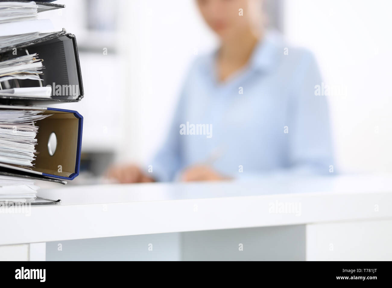 Calculator and binders with papers are waiting to be processed by ...