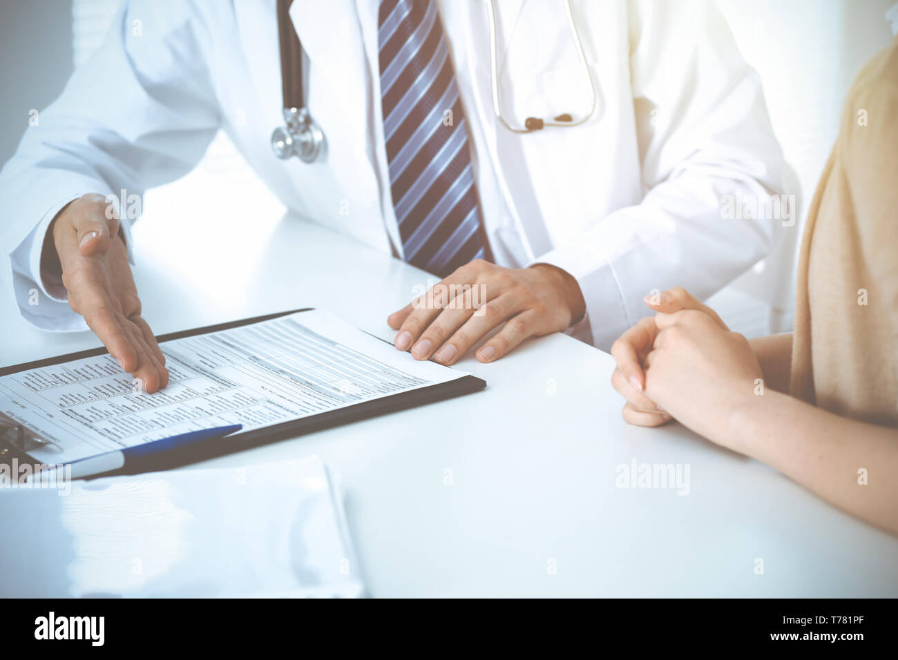 Hand of doctor reassuring her female patient. Concepts of medical ...