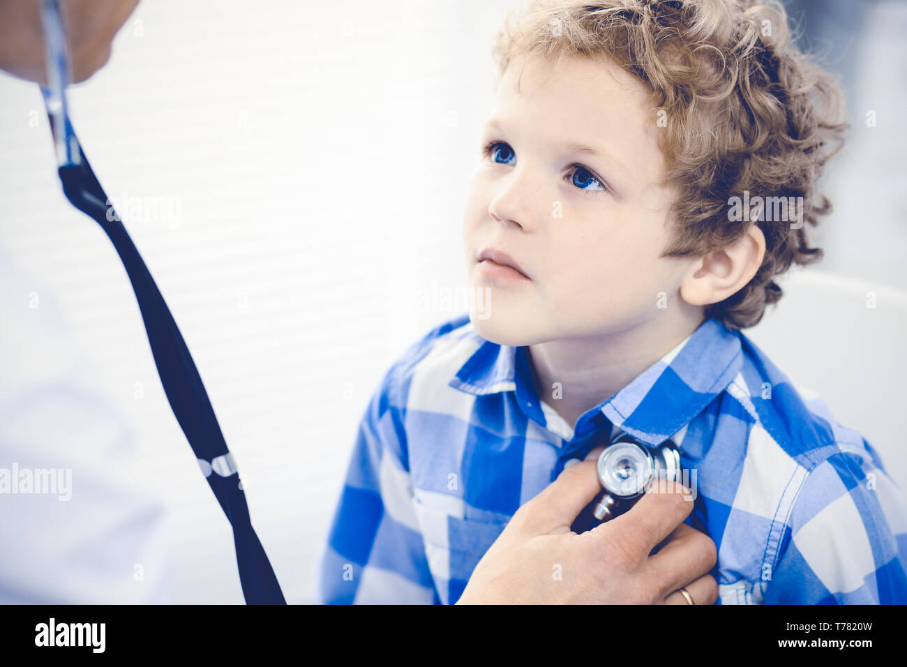 Doctor and patient child. Physician examining little boy. Regular ...