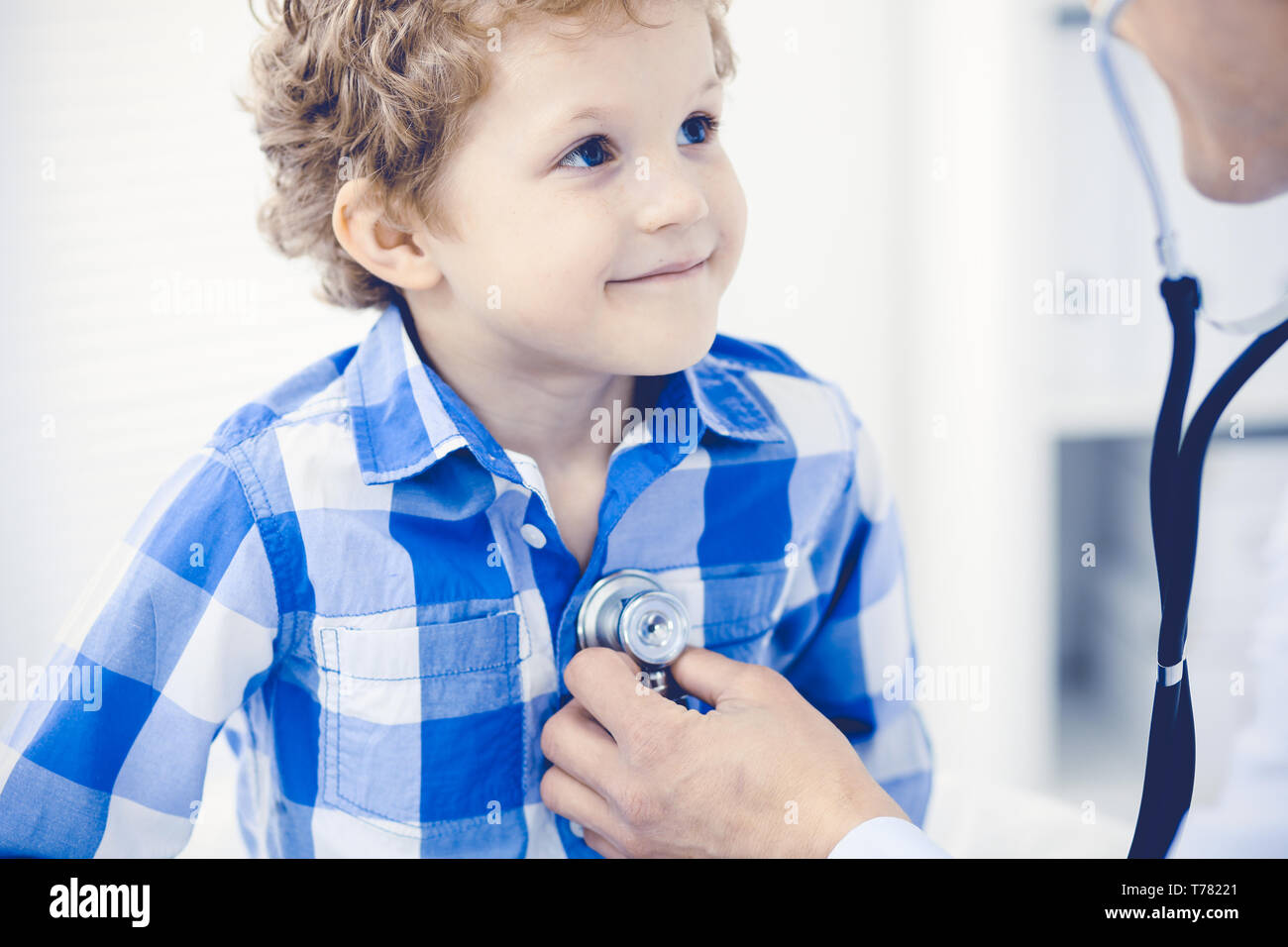 Doctor and patient child. Physician examining little boy. Regular ...