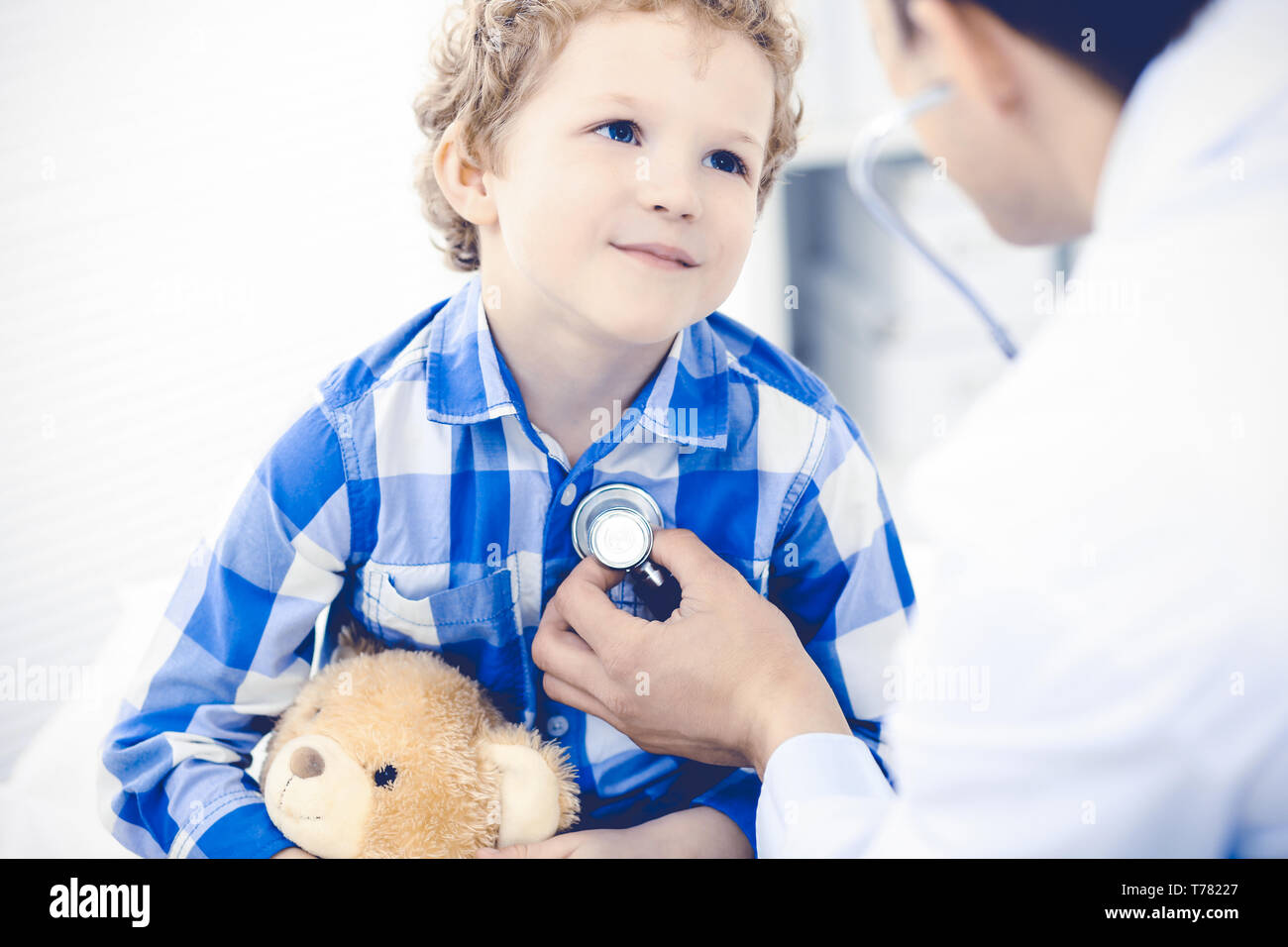 Doctor and patient child. Physician examining little boy. Regular ...