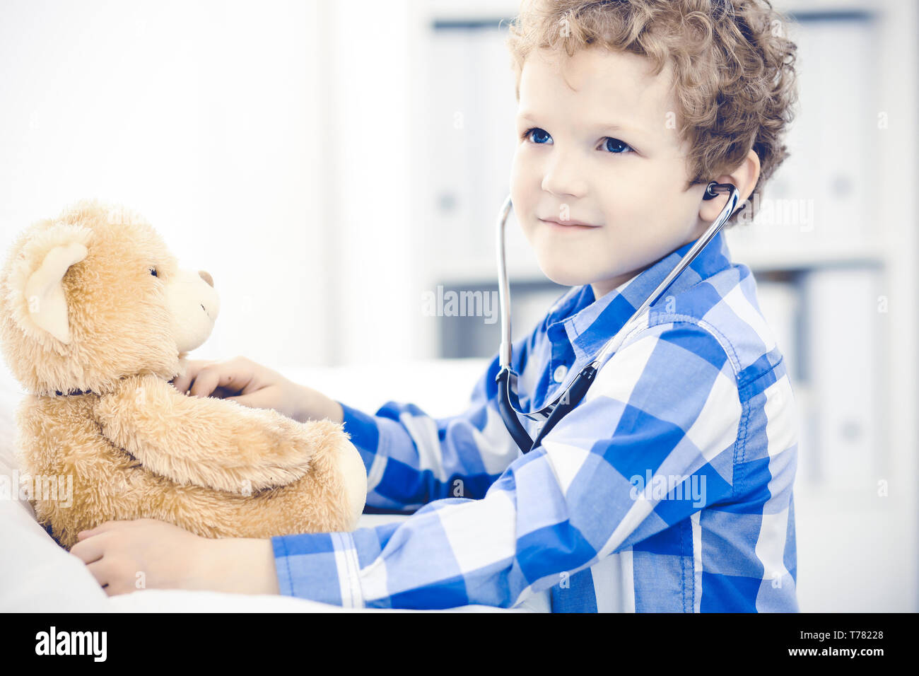 Doctor and patient child. Physician examining little boy. Regular ...