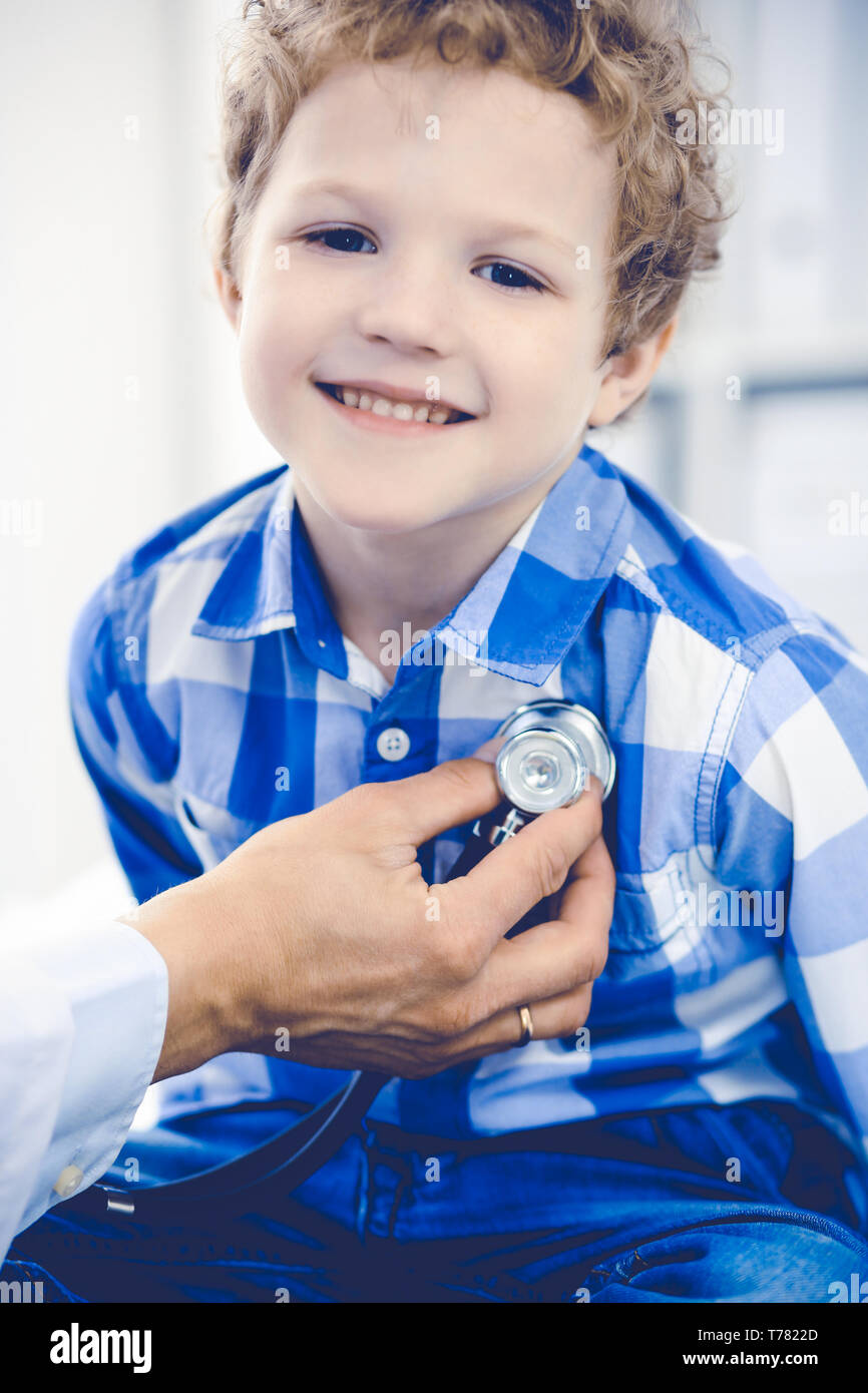 Doctor and patient child. Physician examining little boy. Regular ...