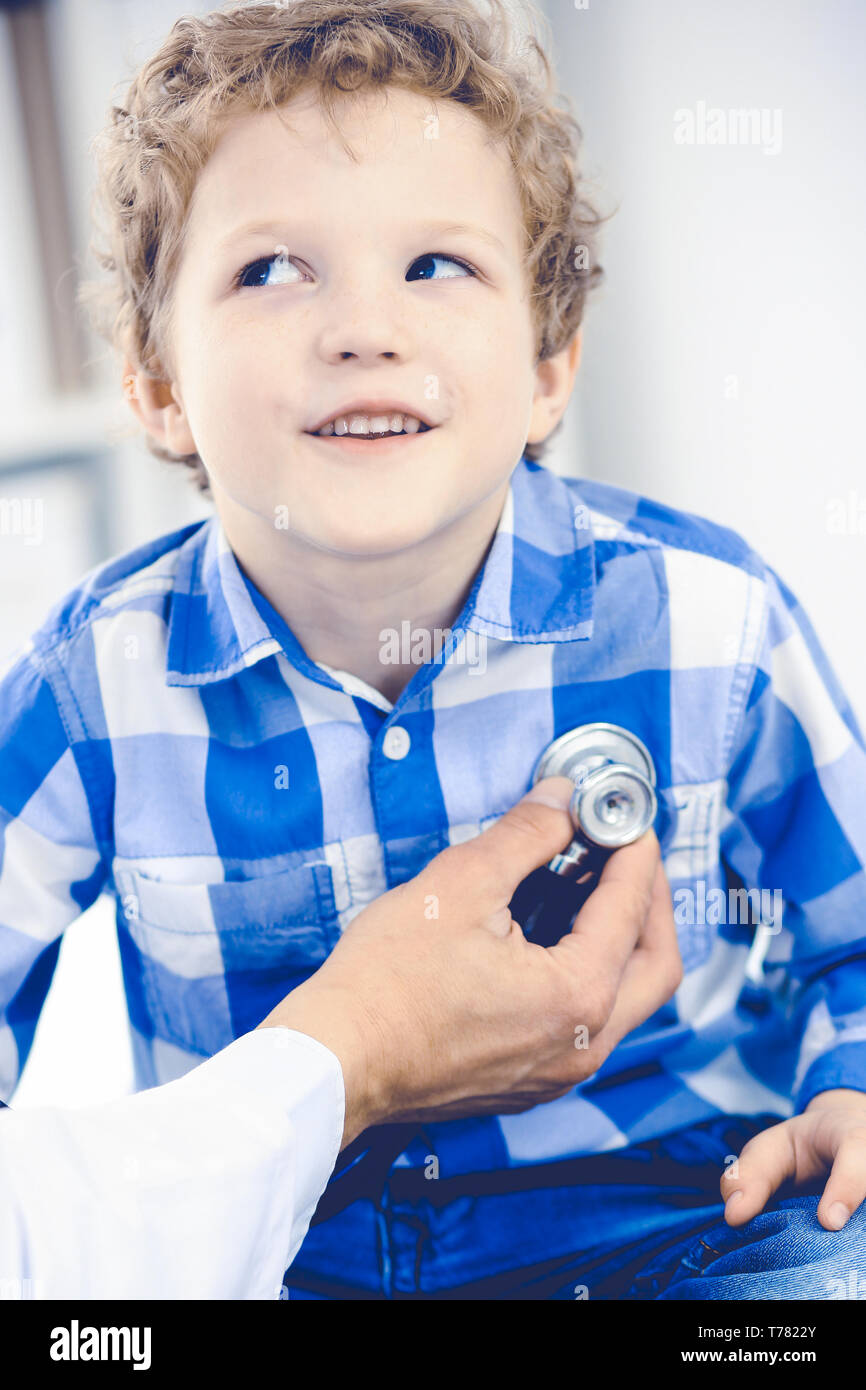 Doctor and patient child. Physician examining little boy. Regular ...