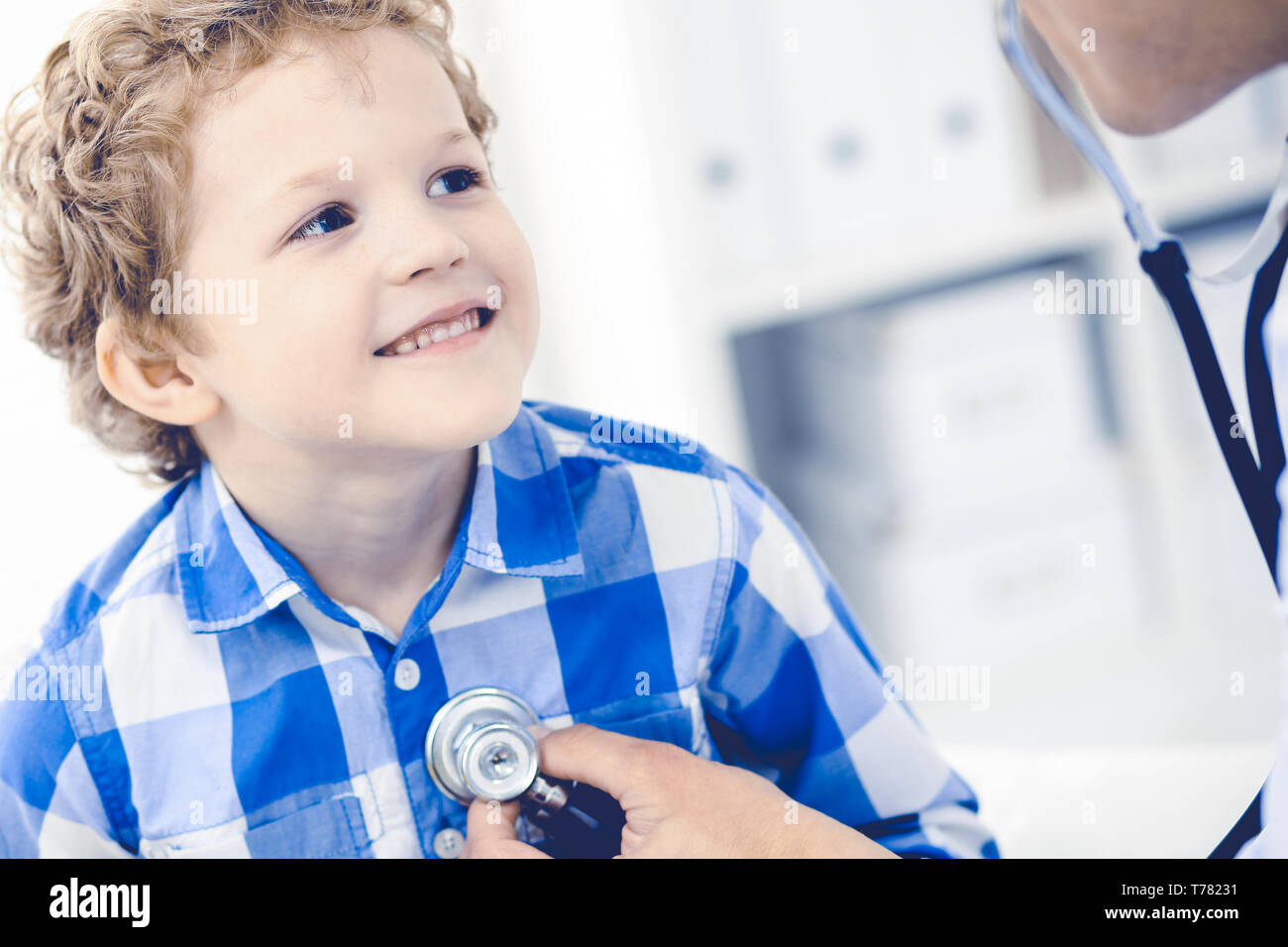Doctor and patient child. Physician examining little boy. Regular ...