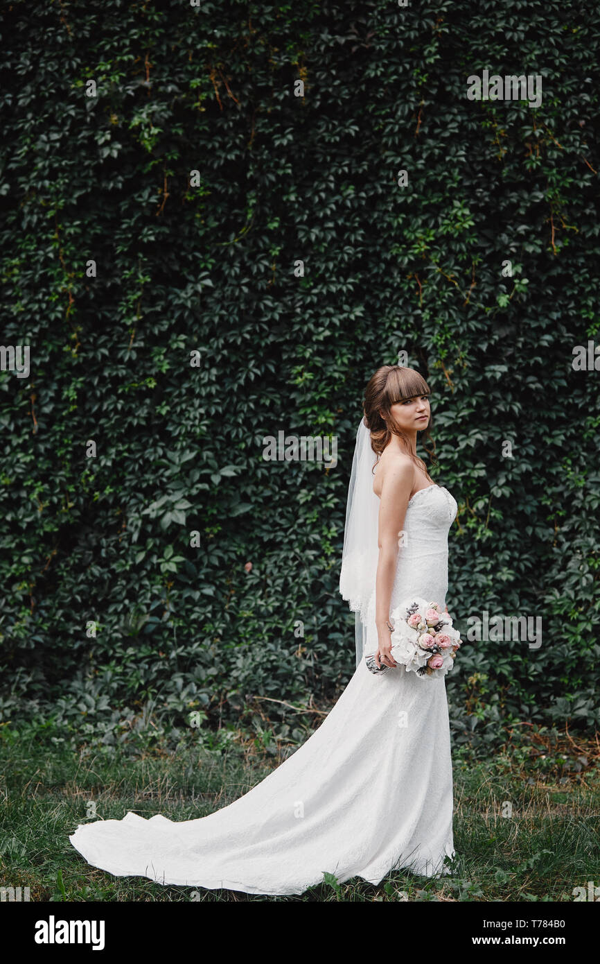 A beautiful bride portrait. Beautiful bride in fashion wedding dress on ...