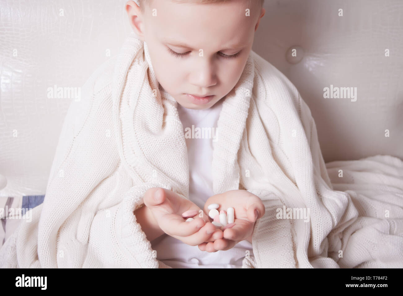 A small child holds in his palm a handful of pills Stock Photo - Alamy