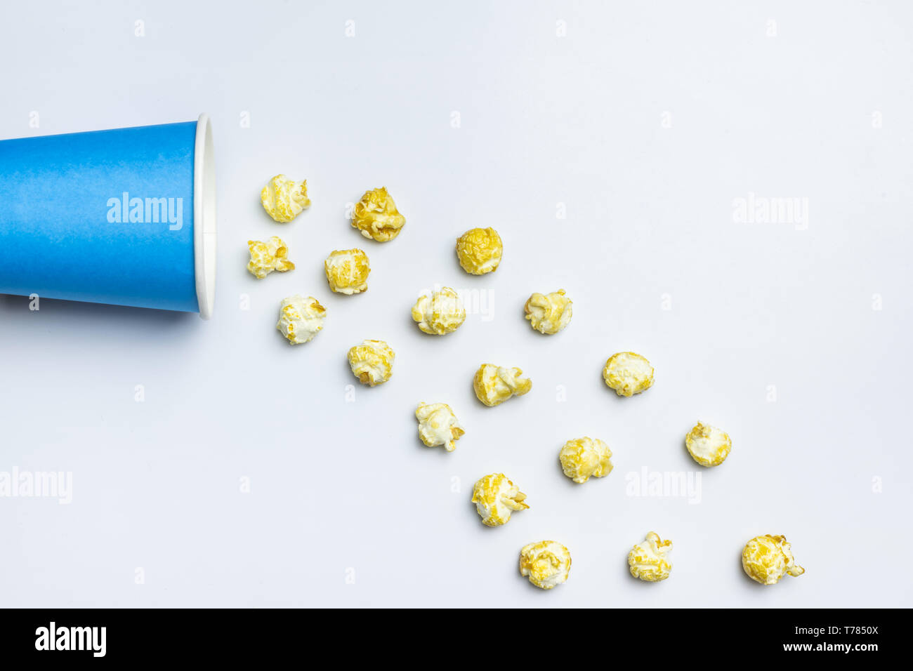 Popcorn spill concept. Isolated white background. Delicious sweet ...